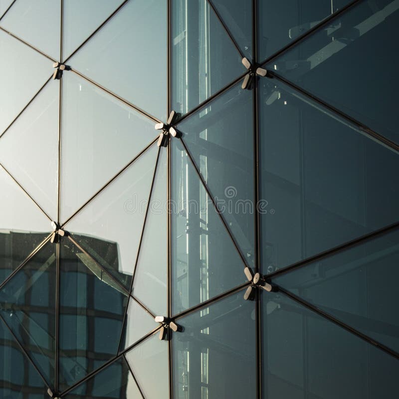 Glass Facade with Geometric, Triangular Panels Secured by Metal ...