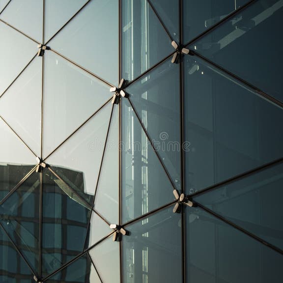 Glass Facade with Geometric, Triangular Panels Secured by Metal ...