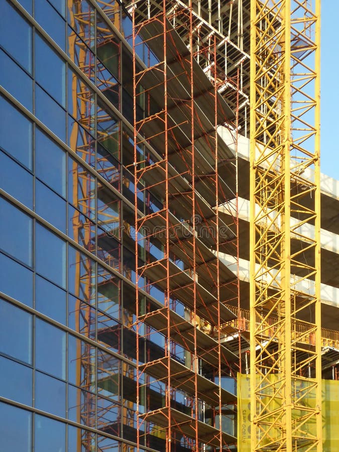 Glass Facade of New Construction Building with Scaffolding and Crane ...