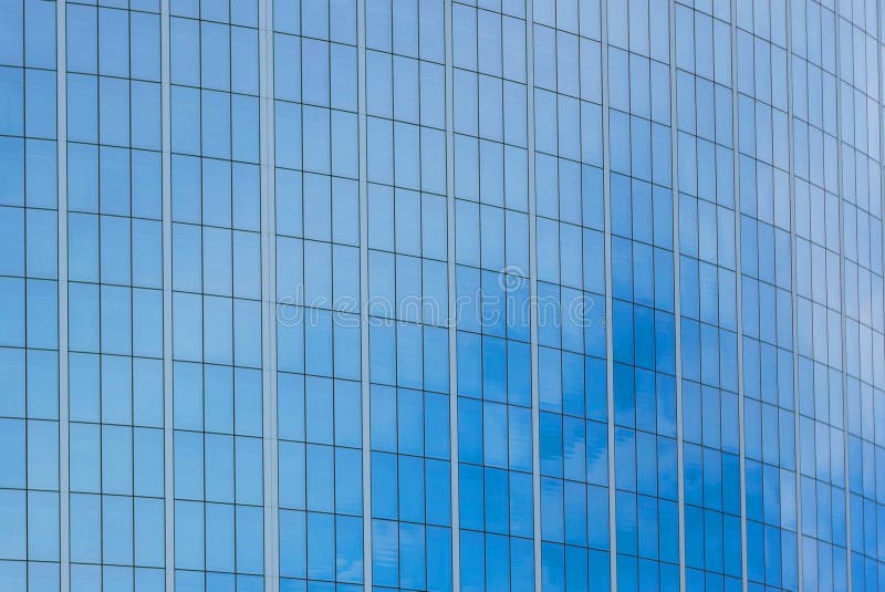 The Glass Facade of a Skyscraper with a Mirror Reflection of Sky ...