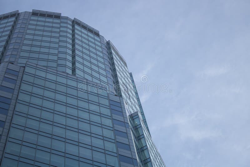 The Glass Facade of a Skyscraper with a Mirror Reflection of Sky ...