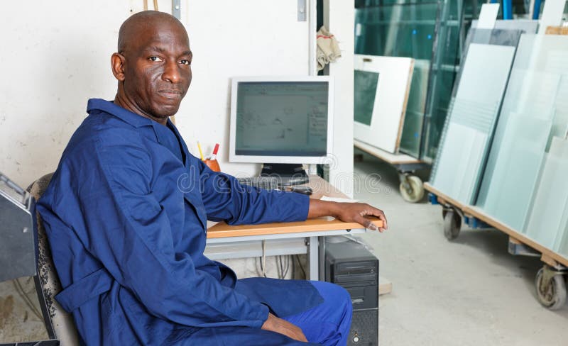 Glass Factory Worker Sitting at Workplace with Computer, Controlling ...
