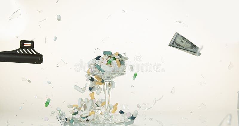 Glass Filled with Capsules and Dollars Exploding Against White ...