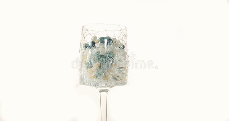 Glass Filled with Capsules Exploding Against White Background Stock ...
