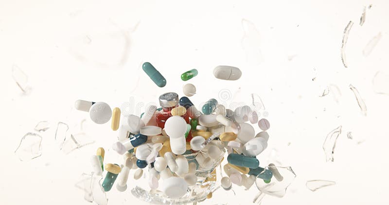 Glass Filled with Capsules Exploding Against White Background Stock ...
