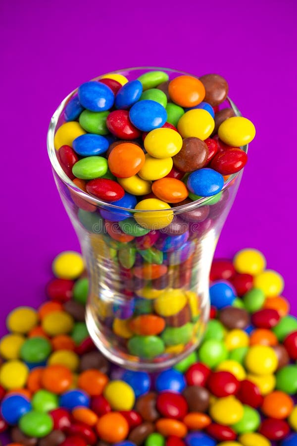 Glass Filled With Rainbow Colored Candy Coated Chocolate Buttons Stock ...