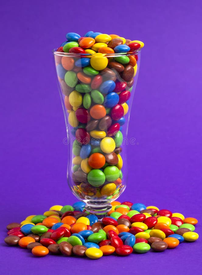 Glass Filled with Rainbow Colored Candy Coated Chocolate Buttons Stock ...