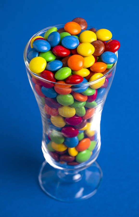 Glass Filled with Rainbow Colored Candy Coated Chocolate Buttons Stock ...