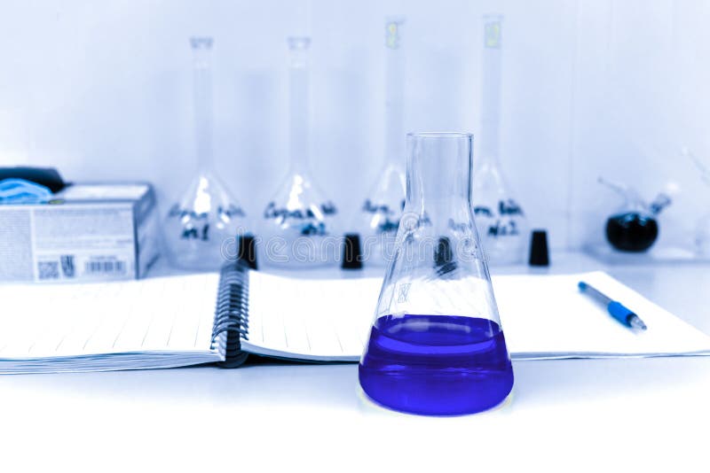 A Glass Flask with a Lilac Reagent Stands on a Table in the Laboratory ...