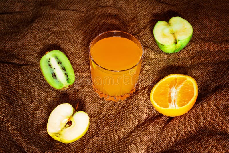 A Glass of Fresh Fruit Juice and Sliced Fruit Wedges Stock Photo ...