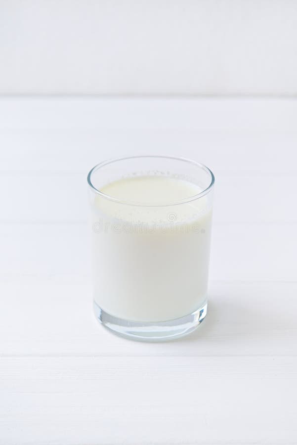Glass of Fresh Milk on a White Wooden Table. Copy Space. Vertical Frame ...