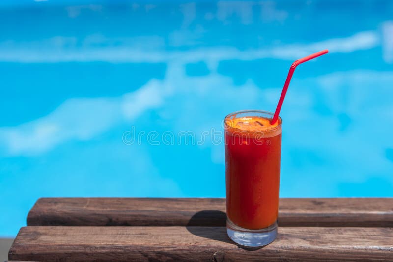 Glass of Fresh Red Orange Juice by the Poolside Stock Photo - Image of ...