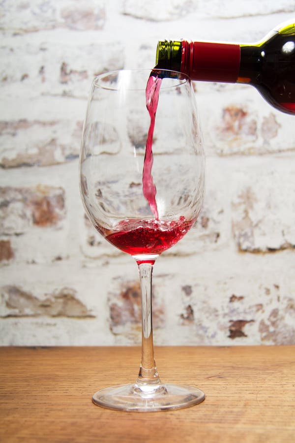 Glass of Full Bodied Red Wine Being Poured Stock Image - Image of ...