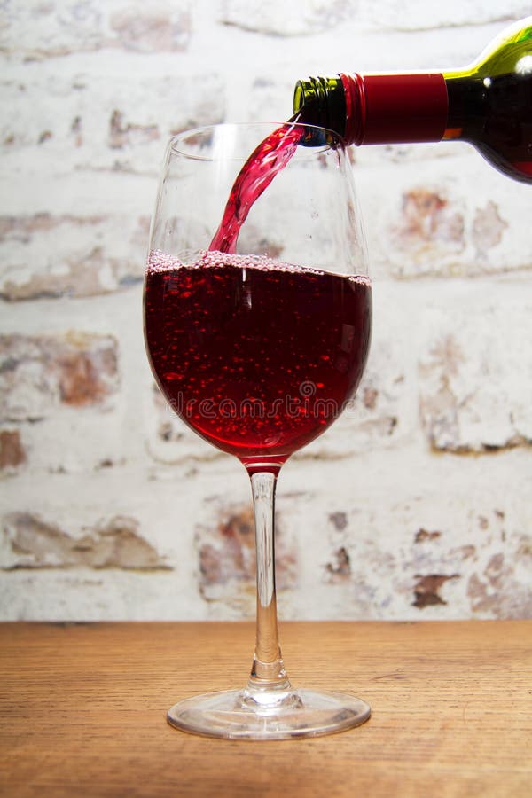 Glass of Full Bodied Red Wine Being Poured Stock Photo - Image of ...