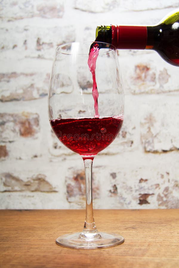 Glass of Full Bodied Red Wine Being Poured Stock Image - Image of ...