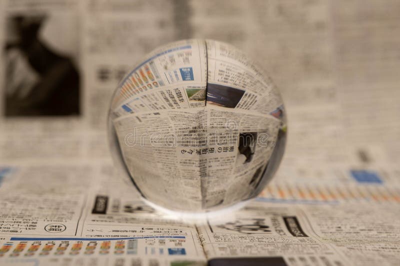 A Glass Globe Reveals the Letters Inside, with a Newspaper in the ...