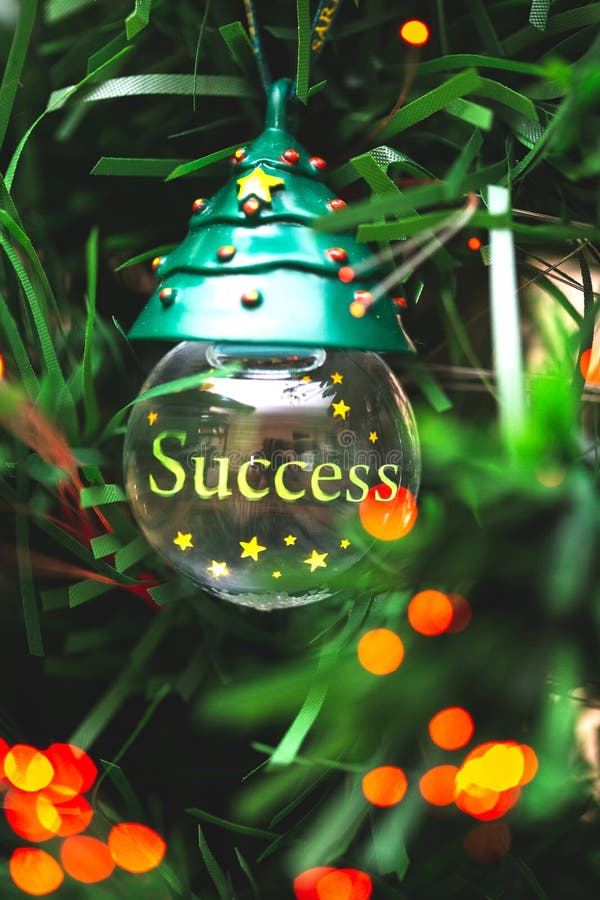 Glass Globe with the Word SUCCESS Hanging in the Christmas Tree Stock ...