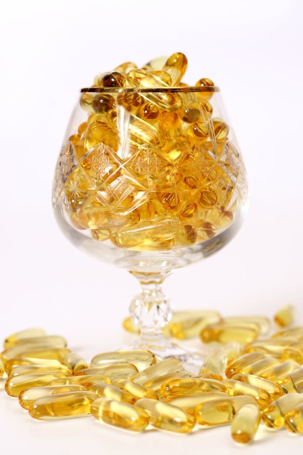 Glass with gold boluses stock photo. Image of bright, pharmacy - 4671158