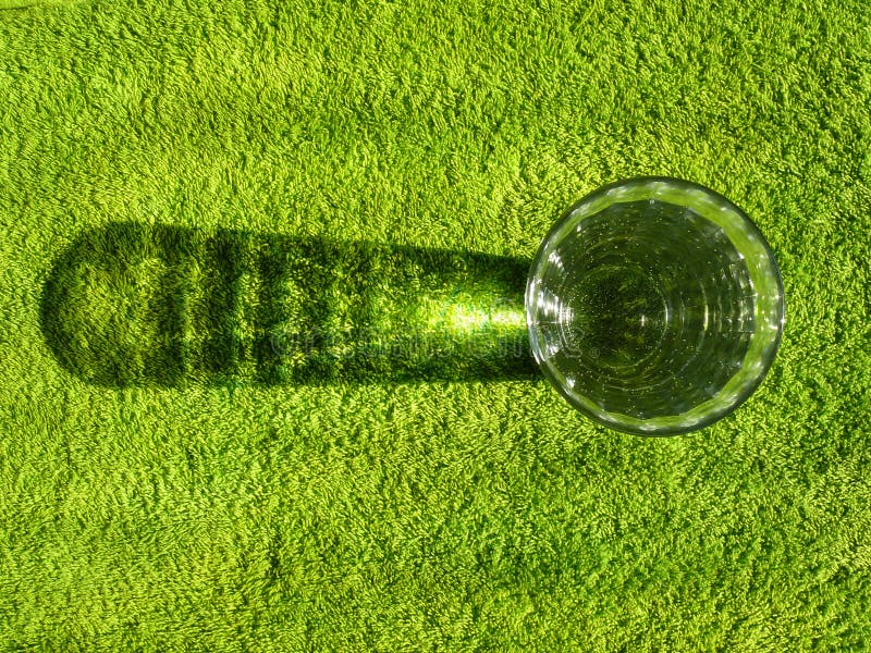 Glass on green stock photo. Image of blue, cool, beam - 8756256