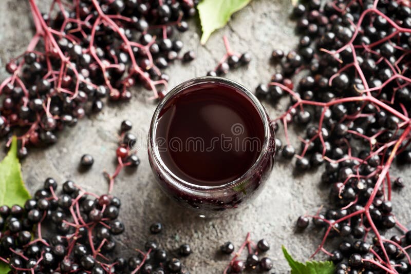 A Glass of Homemade Black Elderberry Syrup on a Table Stock Photo ...