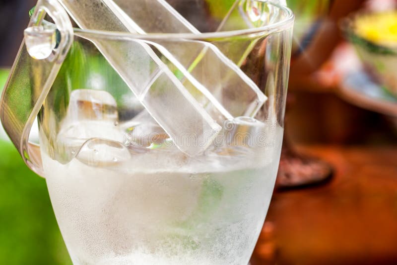 Glass Ice Bucket at a Tropical Caribbean Beach. Taking Ice Cube from ...