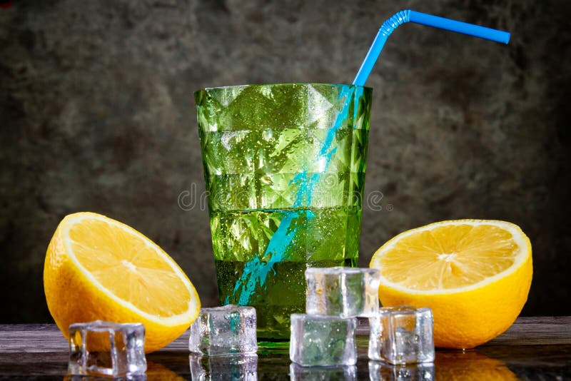 A Glass of Ice-cold Lemon Juice. Fruit Juice with Ice. Lemon Slices and ...