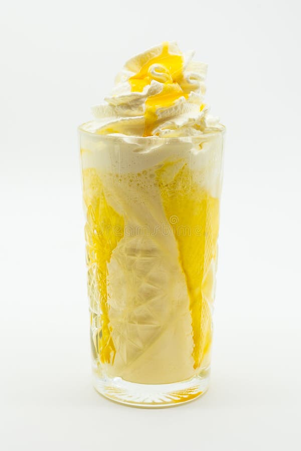 A Glass of Ice Cream with a Yellow Syrup on Top Stock Image - Image of ...