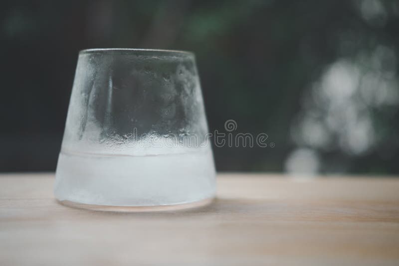 Glass with Ice Freeze on Wood Table Stock Photo - Image of iceberg ...