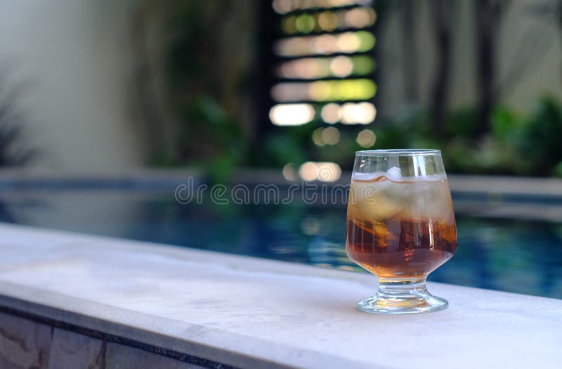 Glass of Ice Tea beside the Pool Stock Photo - Image of condensation ...