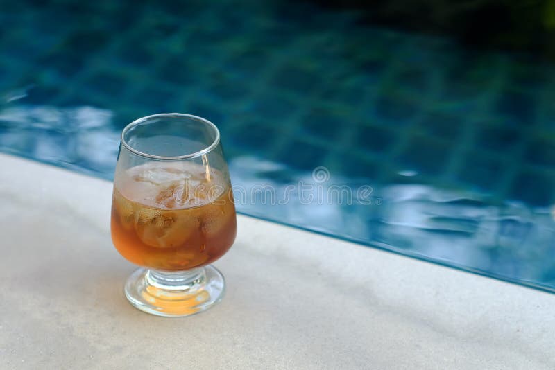 Glass of Ice Tea beside the Pool Stock Photo - Image of brown, shiny ...
