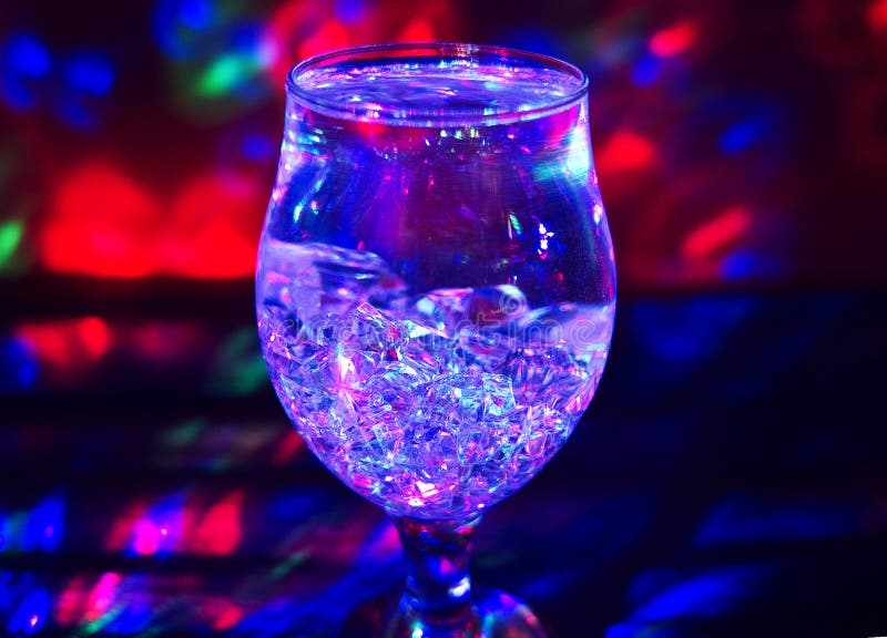 Glass with Ice Which Reflects Multicolored Light. Stock Image - Image ...