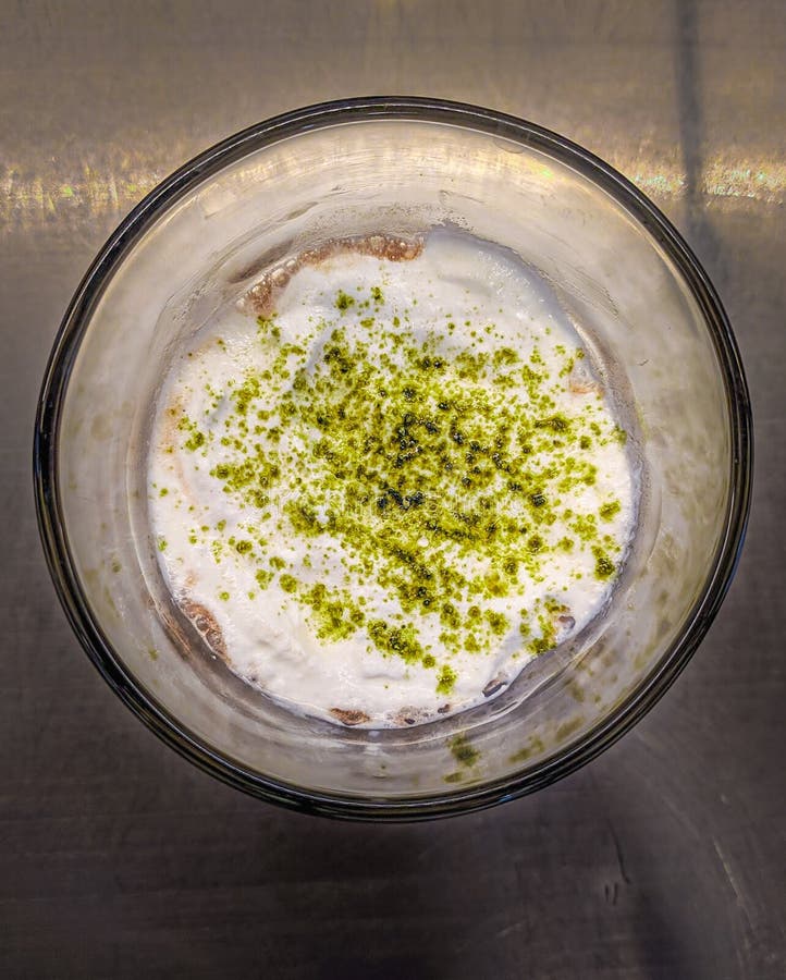Glass Filled with Coffee with Matcha Cap on the Table Stock Image ...