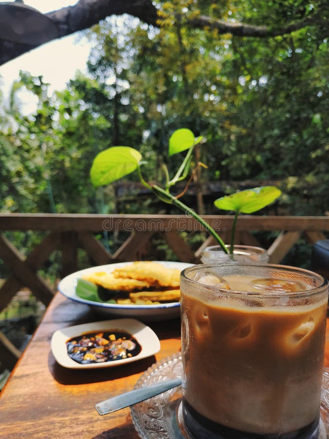 A Glass of Iced Coffee and Milk and Snacks on the Table Stock Photo ...