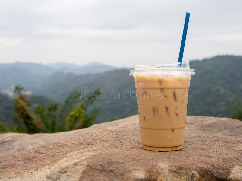 A Glass of Iced Coffee is Placed on a Rock Against a Background of ...