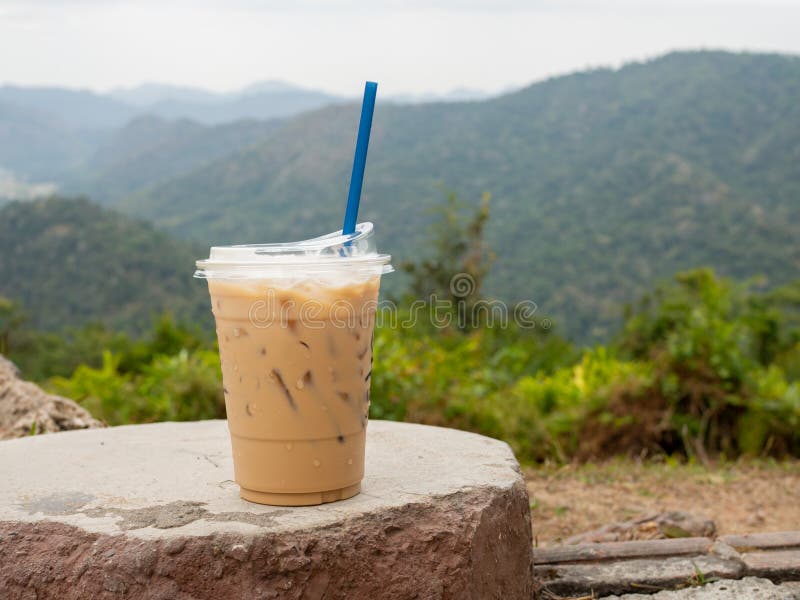 A Glass of Iced Coffee is Placed on a Rock Against a Background of ...