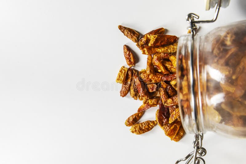 A Glass Jar Full of Dried Cayenne Peppers Overturned on a Smooth Stock ...