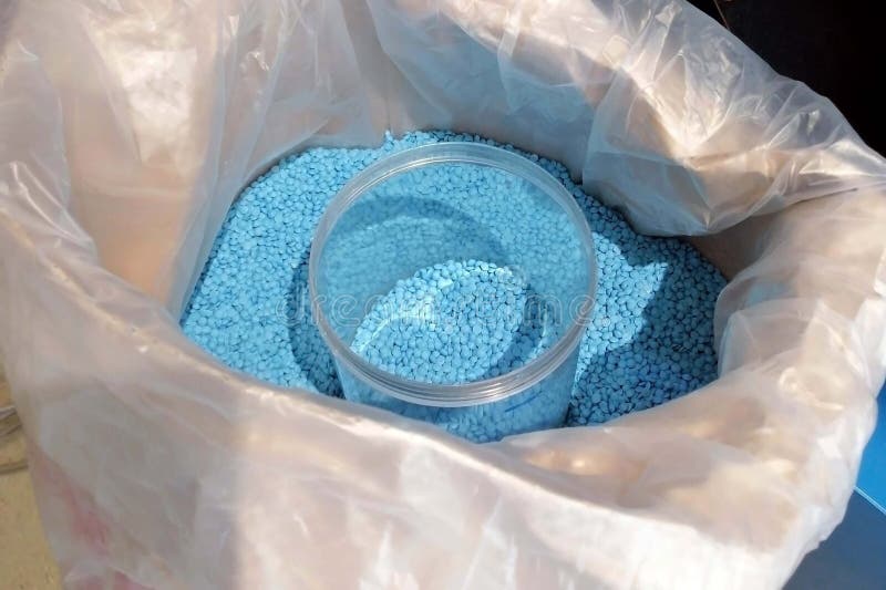 A Glass Jar on a Light Blue Plastic Pellets Bag for Produce a ...