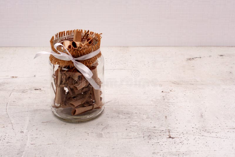 A Glass Jar with Notes of Craft Paper. Light Background. Stock Photo ...