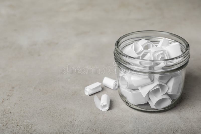 Glass Jar with Paper Pieces on Table, Space for Text Stock Photo ...