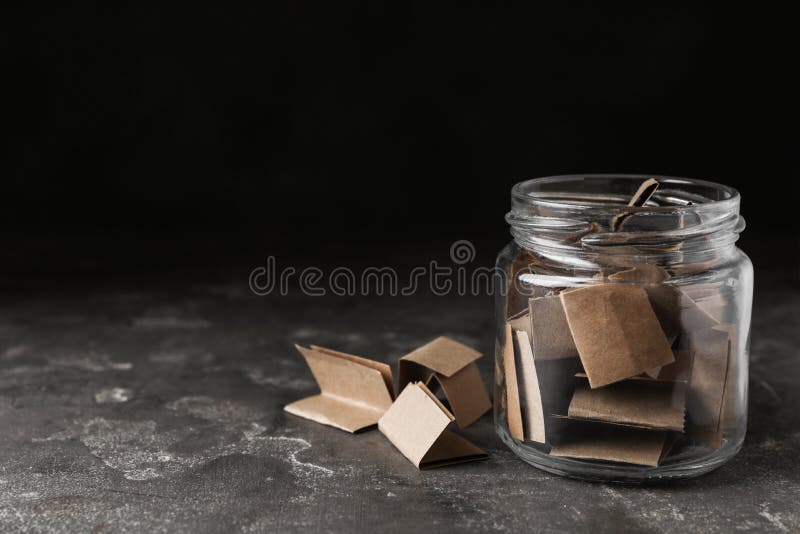 Glass Jar with Paper Pieces on Grey Table, Space for Text Stock Photo ...