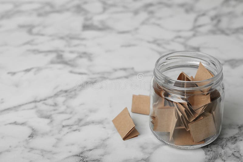 Glass Jar with Paper Pieces on Marble Table, Space for Text Stock Image ...