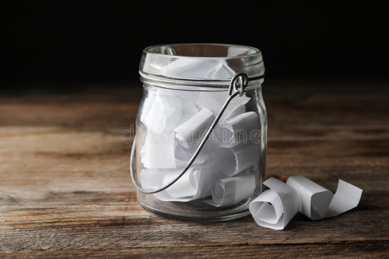 Glass Jar with Paper Pieces on Table Stock Photo - Image of black, note ...