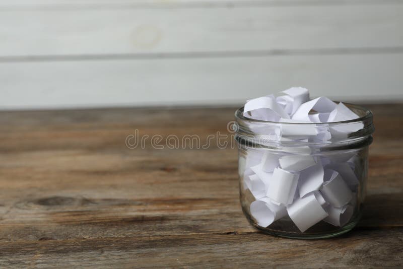 Glass Jar with Paper Pieces on Wooden Table, Space for Text Stock Image ...