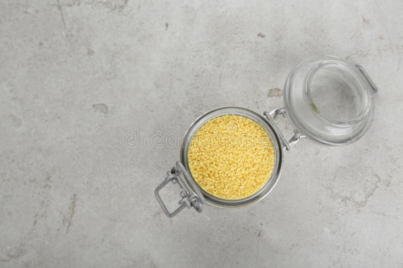 Glass Jar of Raw Couscous on Light Table, Top View. Space for Text ...