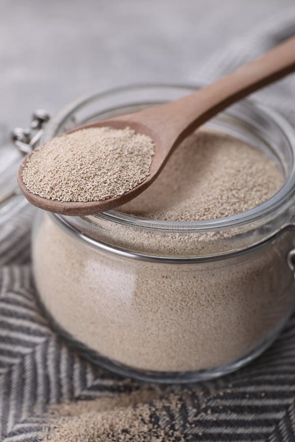 Glass Jar and Spoon with Active Dry Yeast on Light Grey Table, Closeup ...