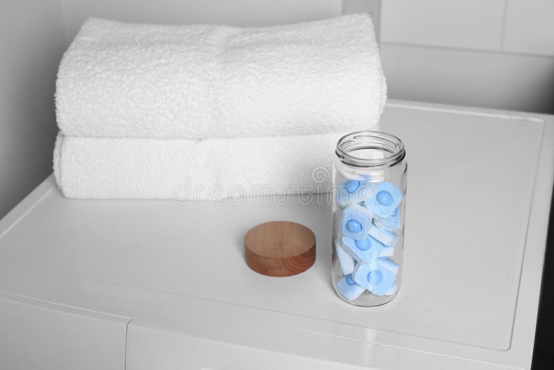 Glass Jar with Water Softener Tablets on Washing Machine in Bathroom ...