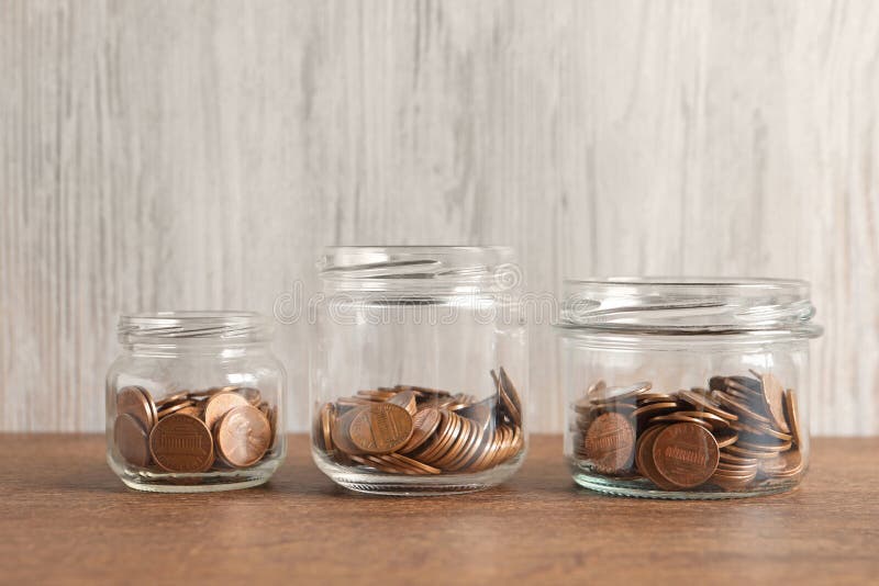 Glass Jars with Coins on Wooden Table Stock Image - Image of business ...