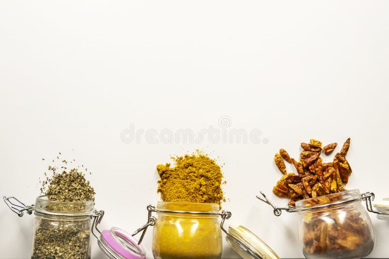 Glass Jars Full of Spices Upended on a Smooth White Surface Stock Image ...