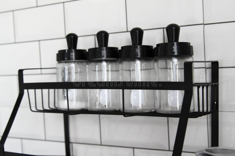 Glass jars stand on shelf stock image. Image of bottle - 237391635