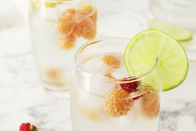 Glass and Jug with Fresh Water and Lime on Marble Table. Space for Text ...